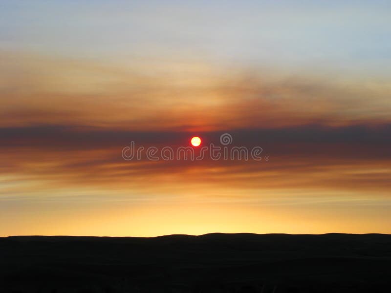 Sun Setting Behind Band of Clouds Stock Photo - Image of line, hazy ...