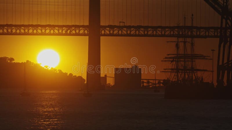 Sunset Behind Water and Bridge in Front of Sailing Vessel Stock Video ...