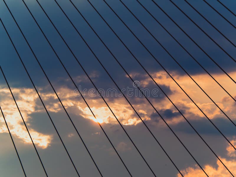 Sun Setting Behind the Clouds Seen through the Cables of the Suspension ...