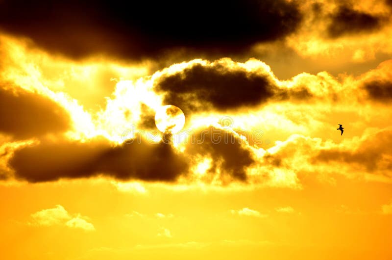 Sun Setting Behind a Cloudy Sky with Beautiful Warm Colors Stock Image ...