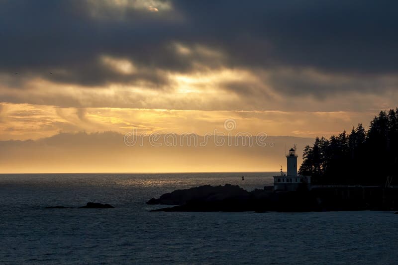 Sun Setting Behind Lighthouse on the Inside Passage of Alaska Stock ...
