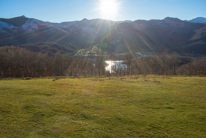 Sun Setting Behind the Mountains Stock Photo - Image of season ...