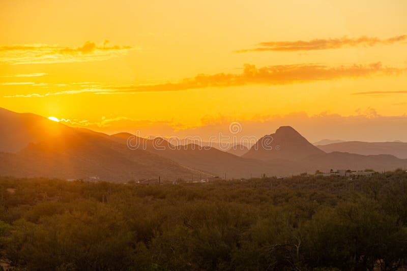 The Sun Setting Behind Mountains in the Sonoran Desert Stock Image ...