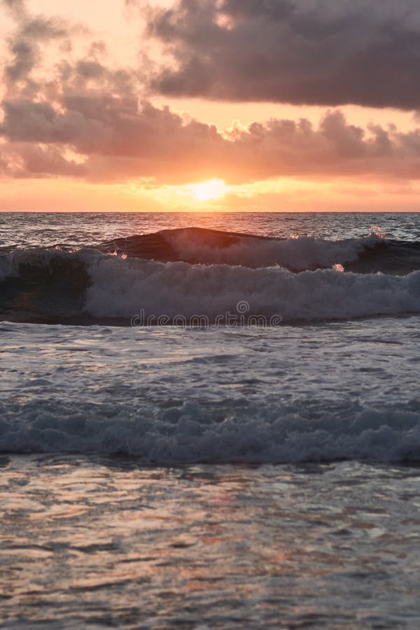 Sun Setting Behind the Ocean with Waves on the Foreground Stock Photo ...