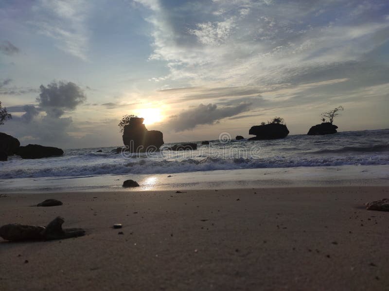 The Sun is Setting Behind the Rock Stock Image - Image of setting, rock ...