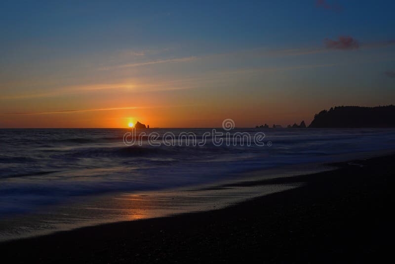 Sun Setting Behind a Sea Stack at Rialto Beach Stock Photo - Image of ...