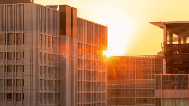 The Sun Setting Behind a Skyscraper in Tokyo Stock Photo - Image of ...