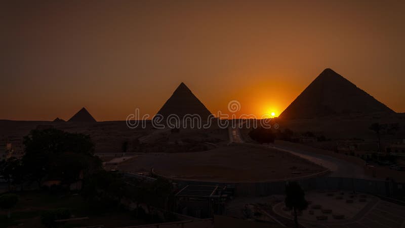 The Sun is Setting Behind the Three Pyramids in Giza, Egypt Stock ...