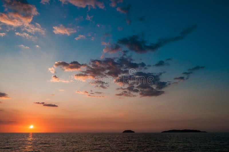 Sun Setting Below the Horizon by Two Island Stock Image - Image of ...