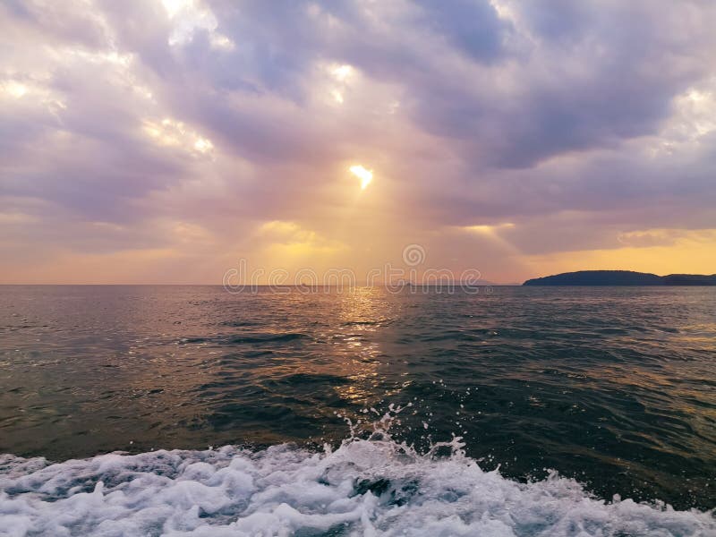 Sun Setting with Cloudy Sky Over Ocean with Waves Stock Photo - Image ...