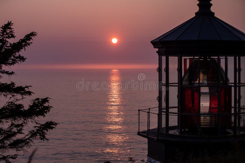 Sun Setting Down Next To the Top of Cape Meares Lighthouse Stock Image ...