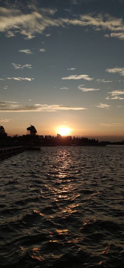 Setting Sun Reflects Golden Orange Light on the Tops of the Mountain ...