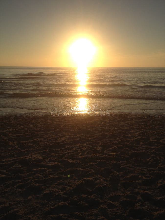 Sunset on beach stock photo. Image of sunset, setting - 102085066