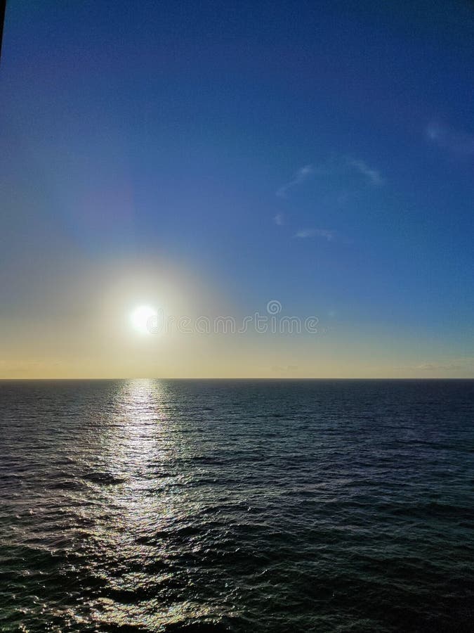 Sun Setting on the Horizon Over the Ocean Stock Photo - Image of ocean ...