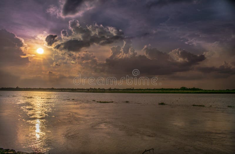 Sun is Setting by Making the Sky Colorful beside River Ganga Stock ...