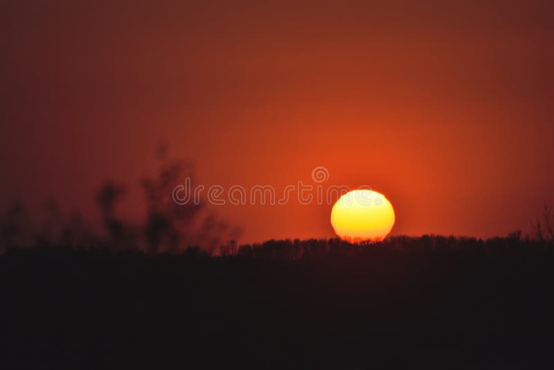 Setting Sun in a Clear Sky. Huge Sun on the Horizon. Stock Photo ...
