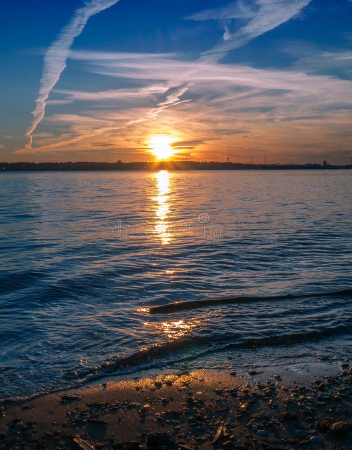 Sun setting over the beach stock image. Image of coast - 134011111