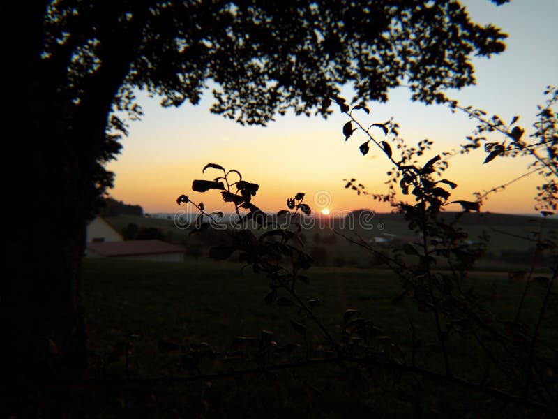 Sun setting over a hill stock photo. Image of dusk, morning - 247582856