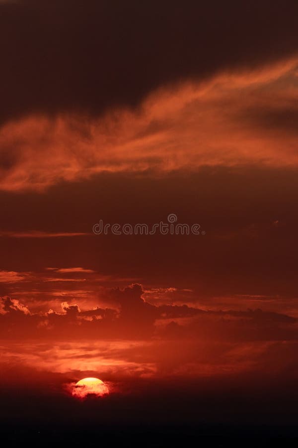 The Sun is Setting Over the Horizon. Beautiful Red Sunset Stock Photo ...