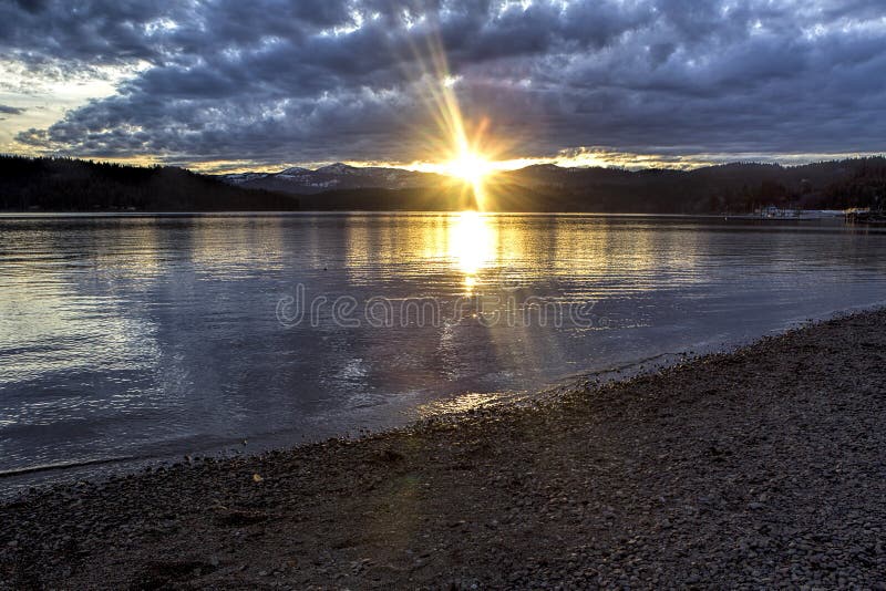 Sun setting over the lake. stock photo. Image of beach - 67875862