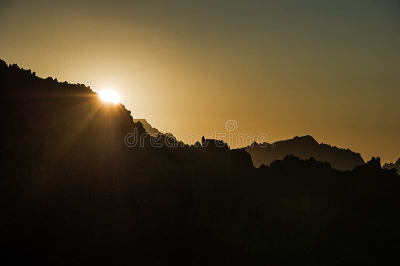 Sun Setting Over Mountain Ridge Stock Photo - Image of rugged, puzzle ...