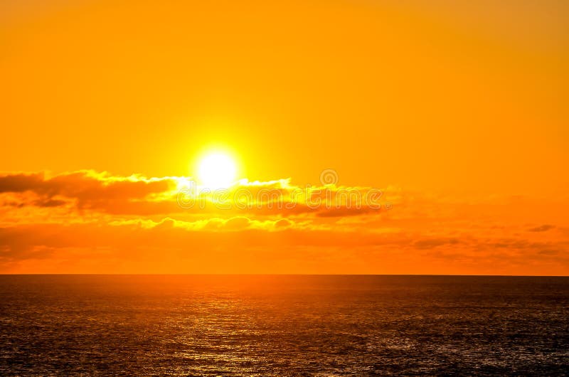 The Sun is Setting Over the Ocean, Casting a Warm Glow Over the Water Stock Image - Image of ...