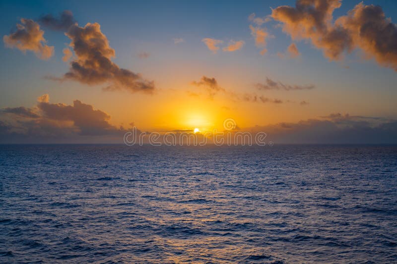The Sun is Setting Over the Ocean on a Clear Day Stock Photo - Image of ...