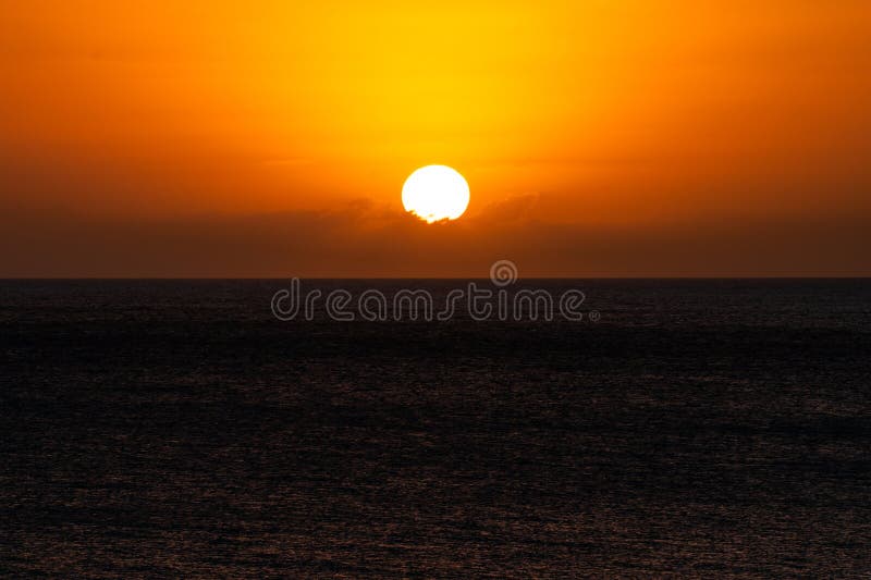 The Sun is Setting Over the Ocean on a Dark Day Stock Photo - Image of ...