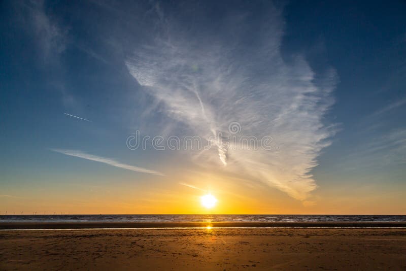 The Sun Setting Over the Ocean, at Formby in Merseyside Stock Photo ...