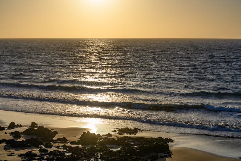 Sun setting over the ocean stock photo. Image of waves - 170110248