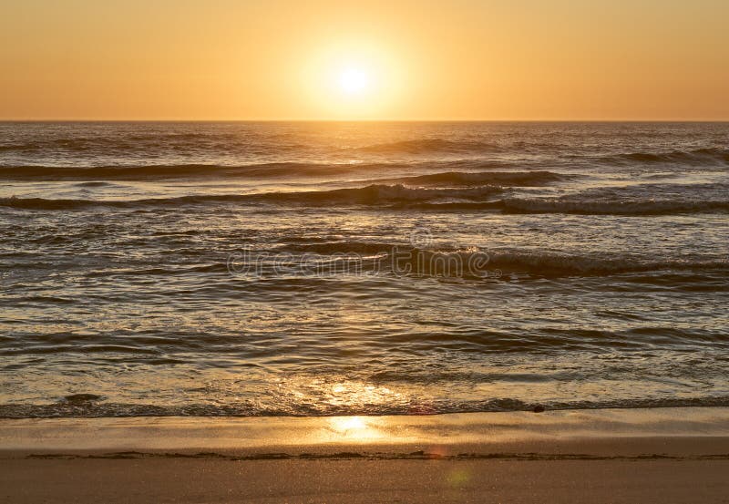 Sun Setting Over Ocean Waves and Beach in South Africa Stock Image ...
