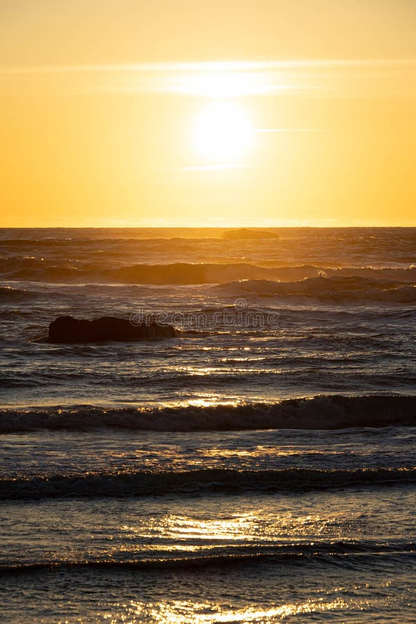 The Sun Setting Over the Rough Seas of the Pacific Ocean Stock Photo ...