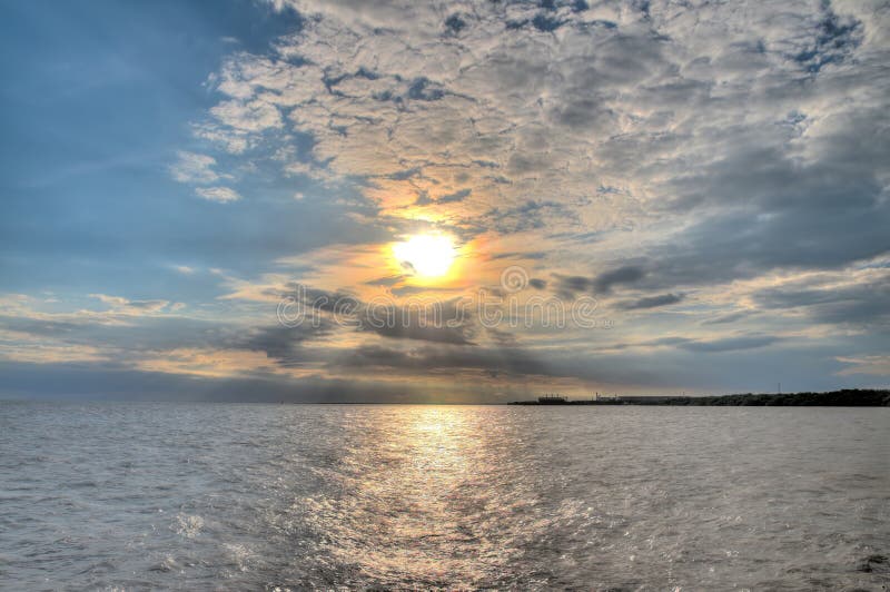 Sun Setting Over the Sea stock image. Image of coastline - 217415769