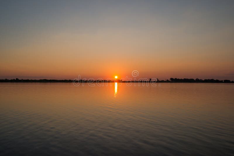 Sun Setting Over Trees on River Bank Stock Photo - Image of nature ...