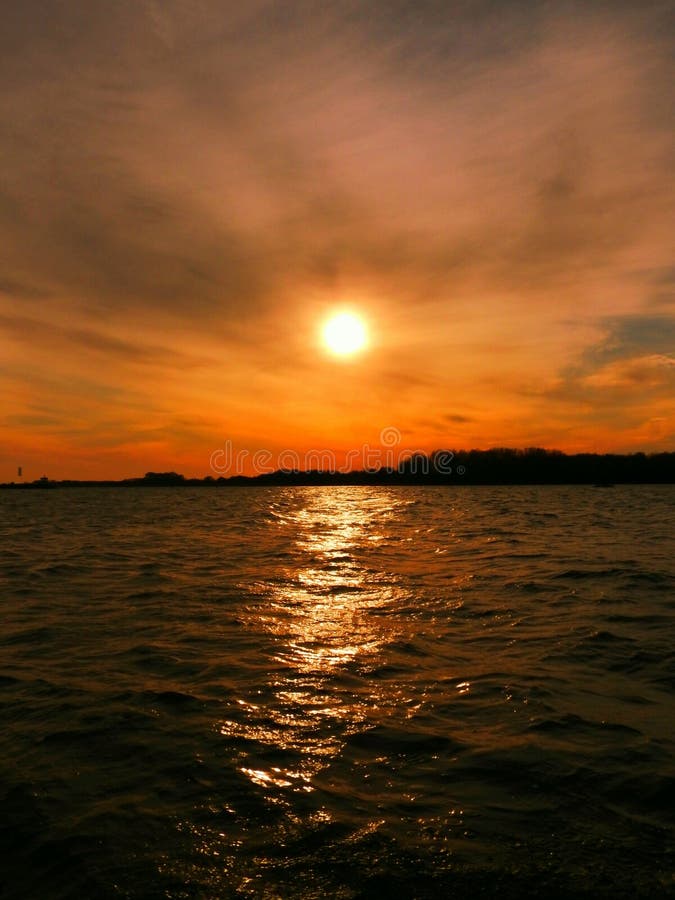 Sun Setting Over the Water Red Glare Low Sun Stock Photo - Image of ...