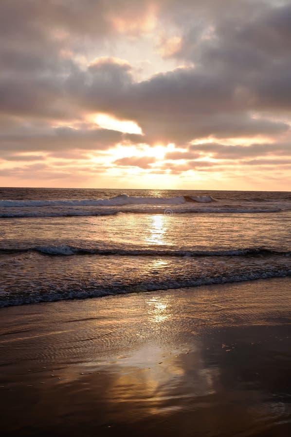 The Sun Setting into the Pacific Ocean Seen from a Beach Stock Photo ...