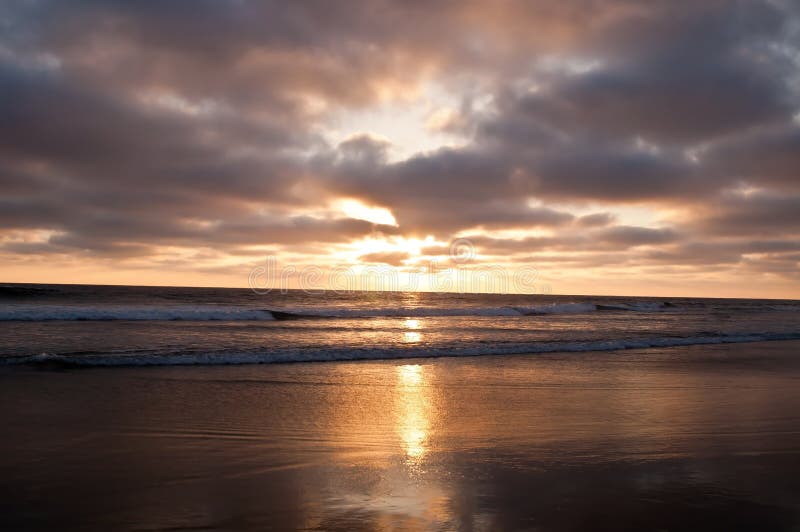 The Sun Setting into the Pacific Ocean Seen from a Beach Stock Photo ...