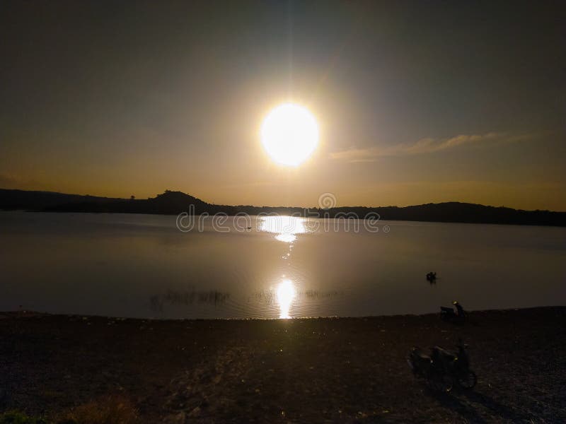 The Sun is Setting on the Western Horizon of the Lake Stock Photo ...