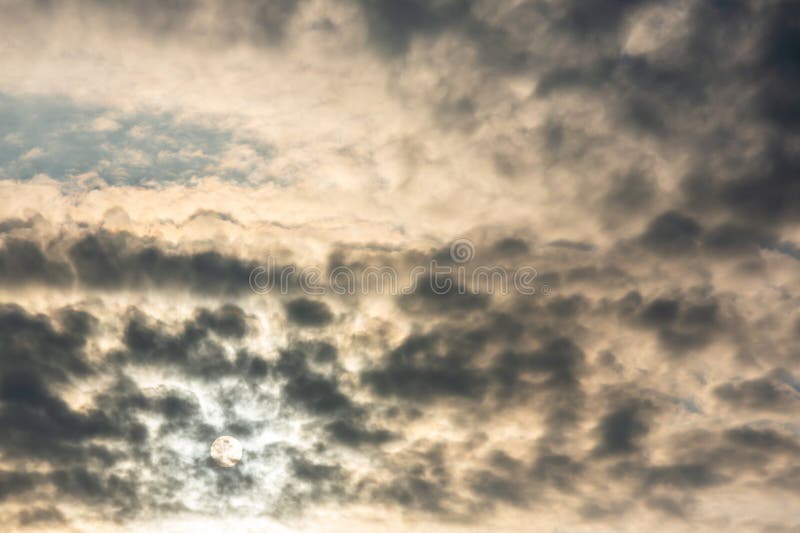 Dramatic Cloudy Sky with Sun Partially Hidden Stock Image - Image of ...