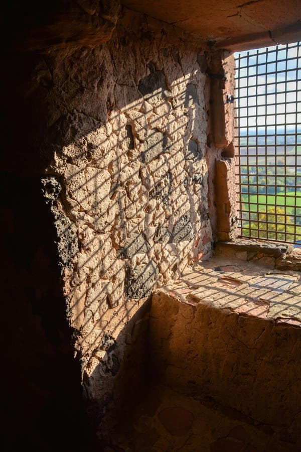 Sun Shines through an Old Castle Window with Bars with Shadows on the ...