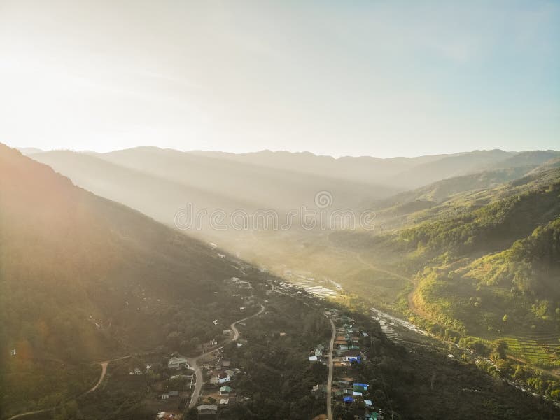 The Sun Shines Over the Top of the Mountain Creating Beautiful Rays ...