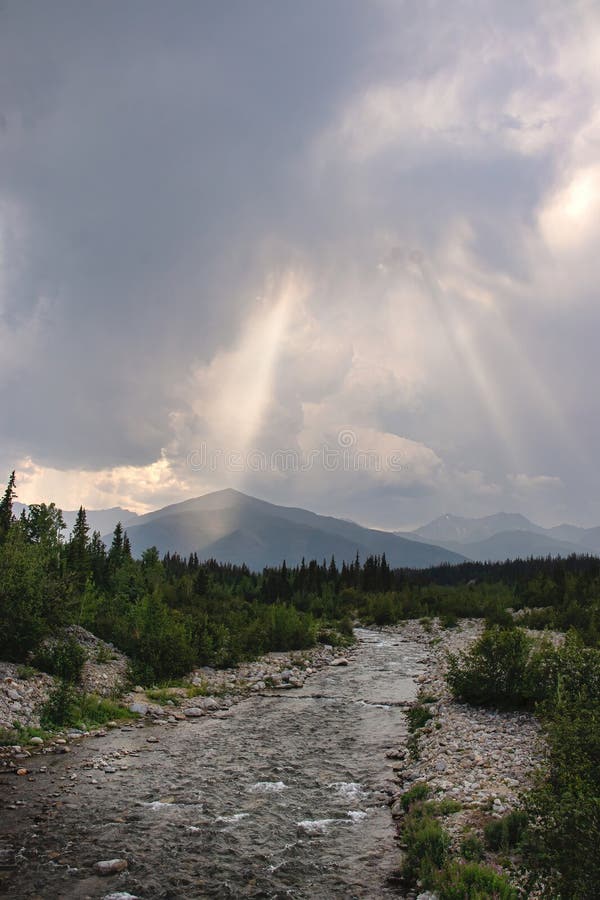 Sun Shining on a Mountain through Clouds in Alaska Stock Photo - Image ...