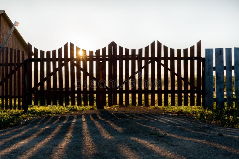 Sun is Shining through Wooden Gate at Dawn in Summer. Stock Photo ...
