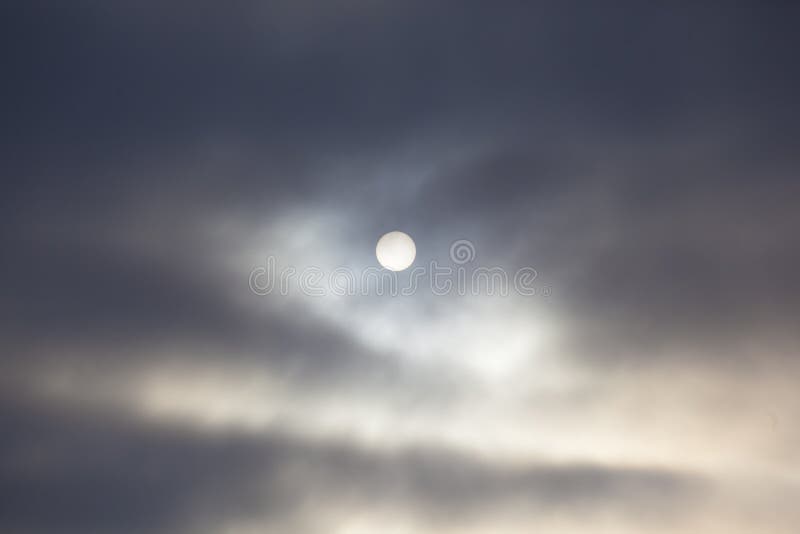 Sun Shining through a Thick Layer of Clouds on a Misty Morning Stock ...