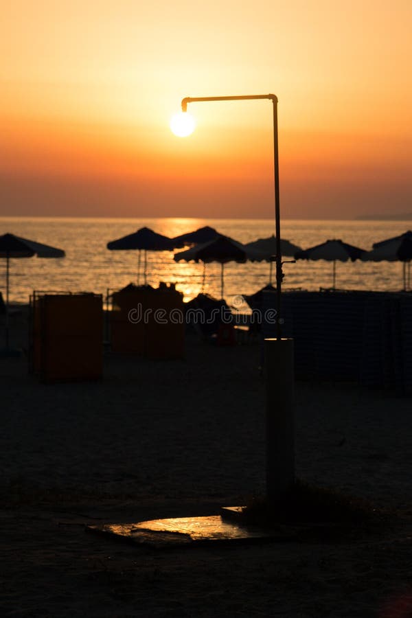 Sun shower over beach stock photo. Image of lifestyle - 144628018
