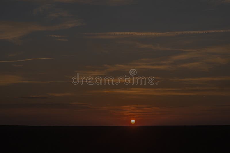 Sun sinking on the horizon stock image. Image of beauty - 258646275