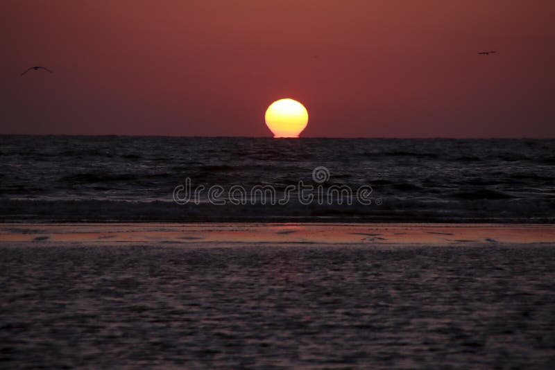 Sun Sinks into the Sea on the Beach of Katwijk with Colorful Sky Stock ...