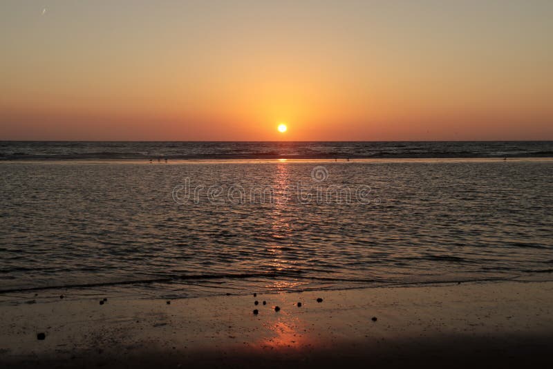 Sun Sinks into the Sea on the Beach of Katwijk with Colorful Sky Stock ...