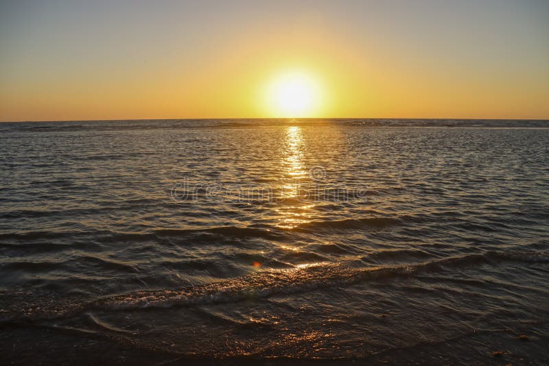 Sun Sinks into the Sea on the Beach of Katwijk with Colorful Sky Stock ...