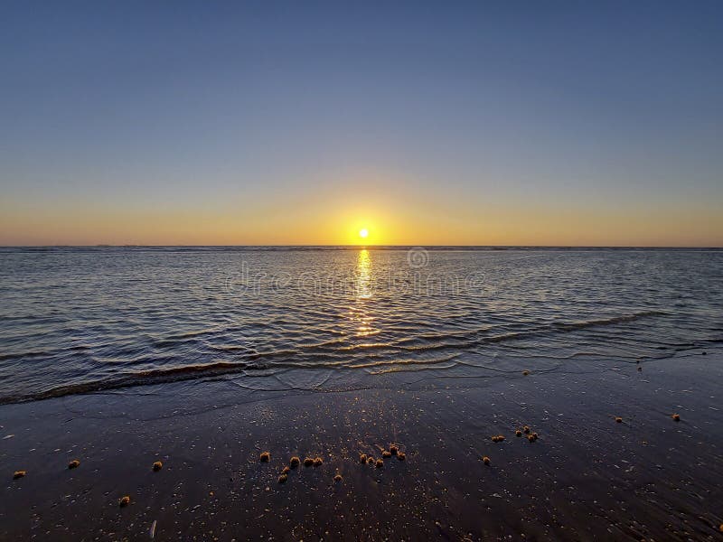 Sun Sinks into the Sea on the Beach of Katwijk with Colorful Sky Stock ...